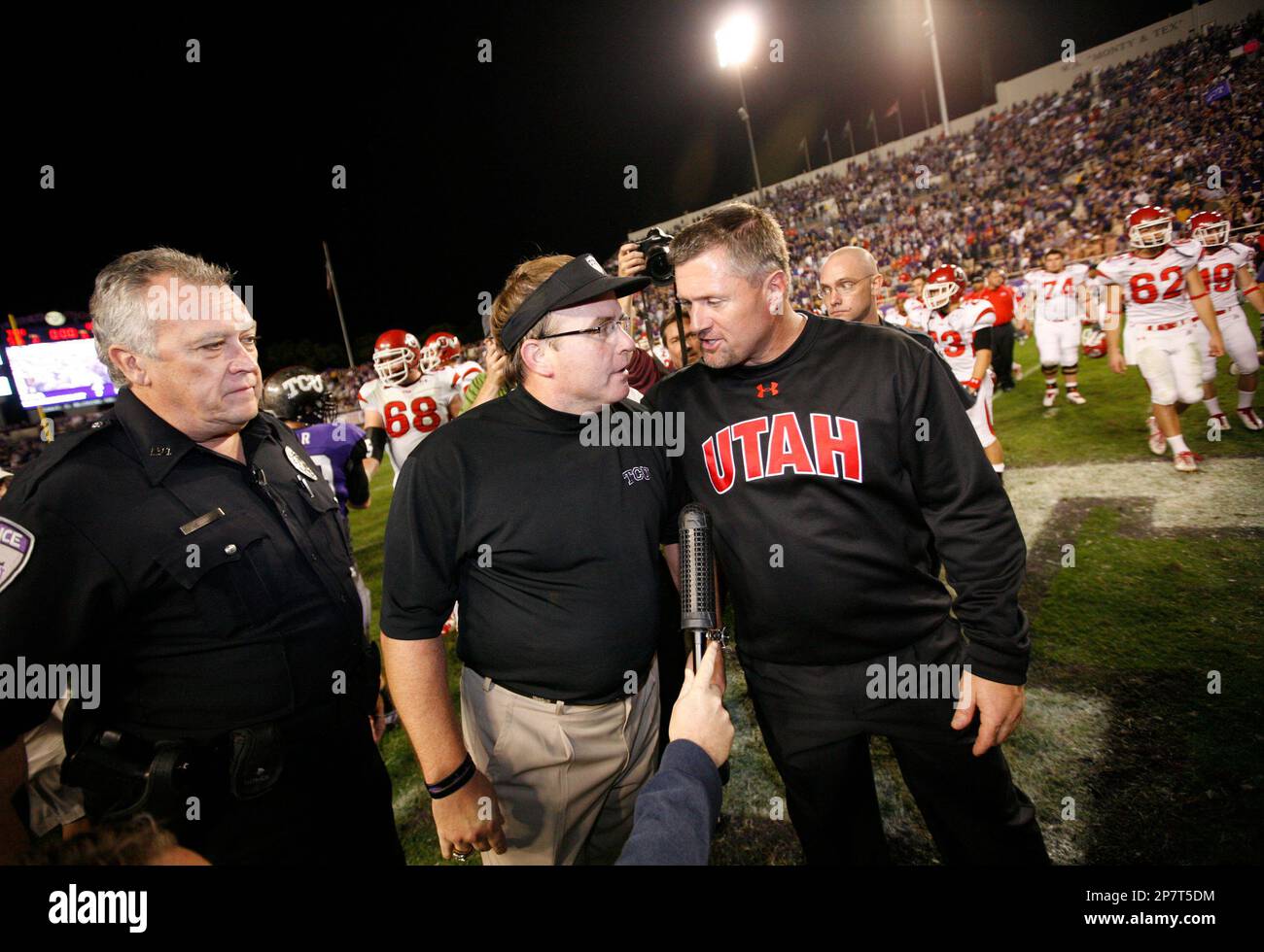 TCU head coach Gary Patterson, center, greets Utah head coach Kyle ...