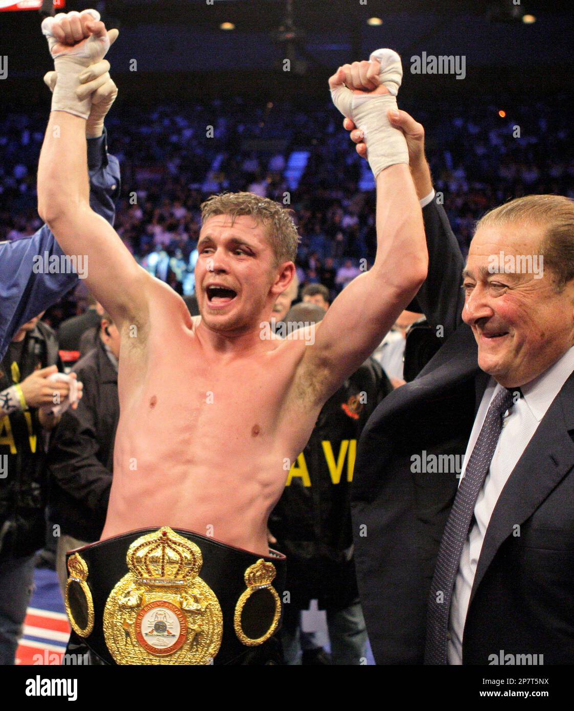 Fight promoter Bob Arum, right, raises the hand of boxer Yuri Foreman ...