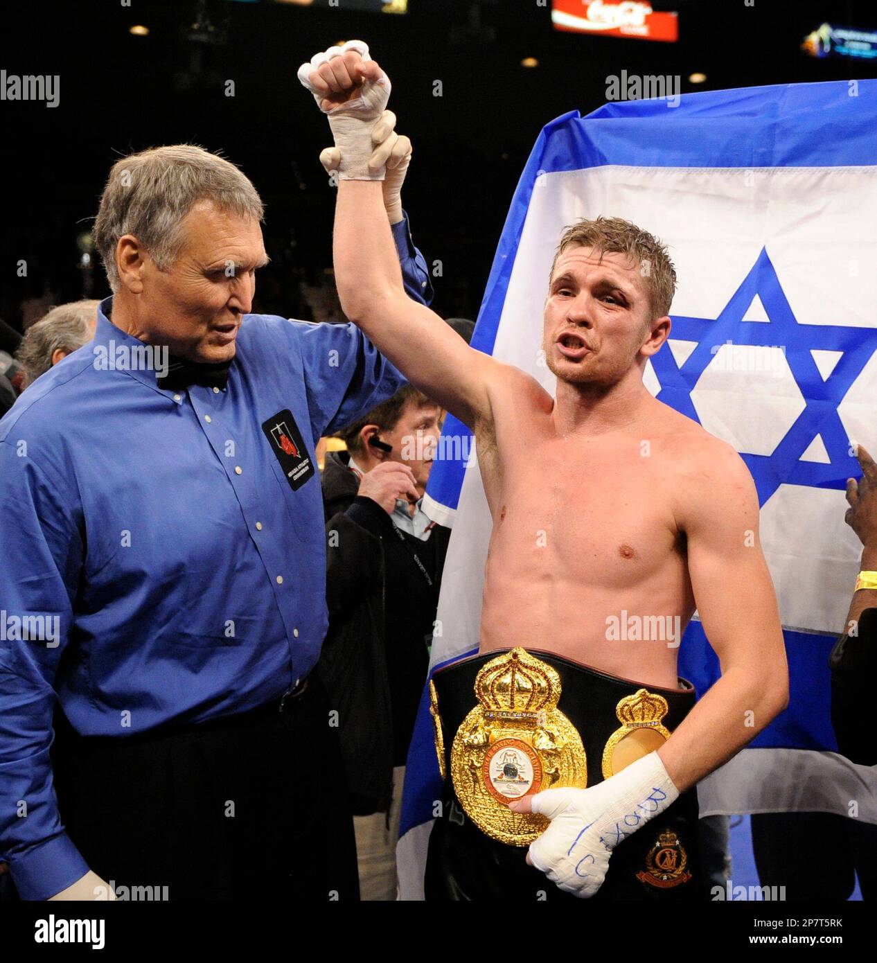 Referee Jay Nady, left, raises the hand of boxer Yuri Foreman, from ...