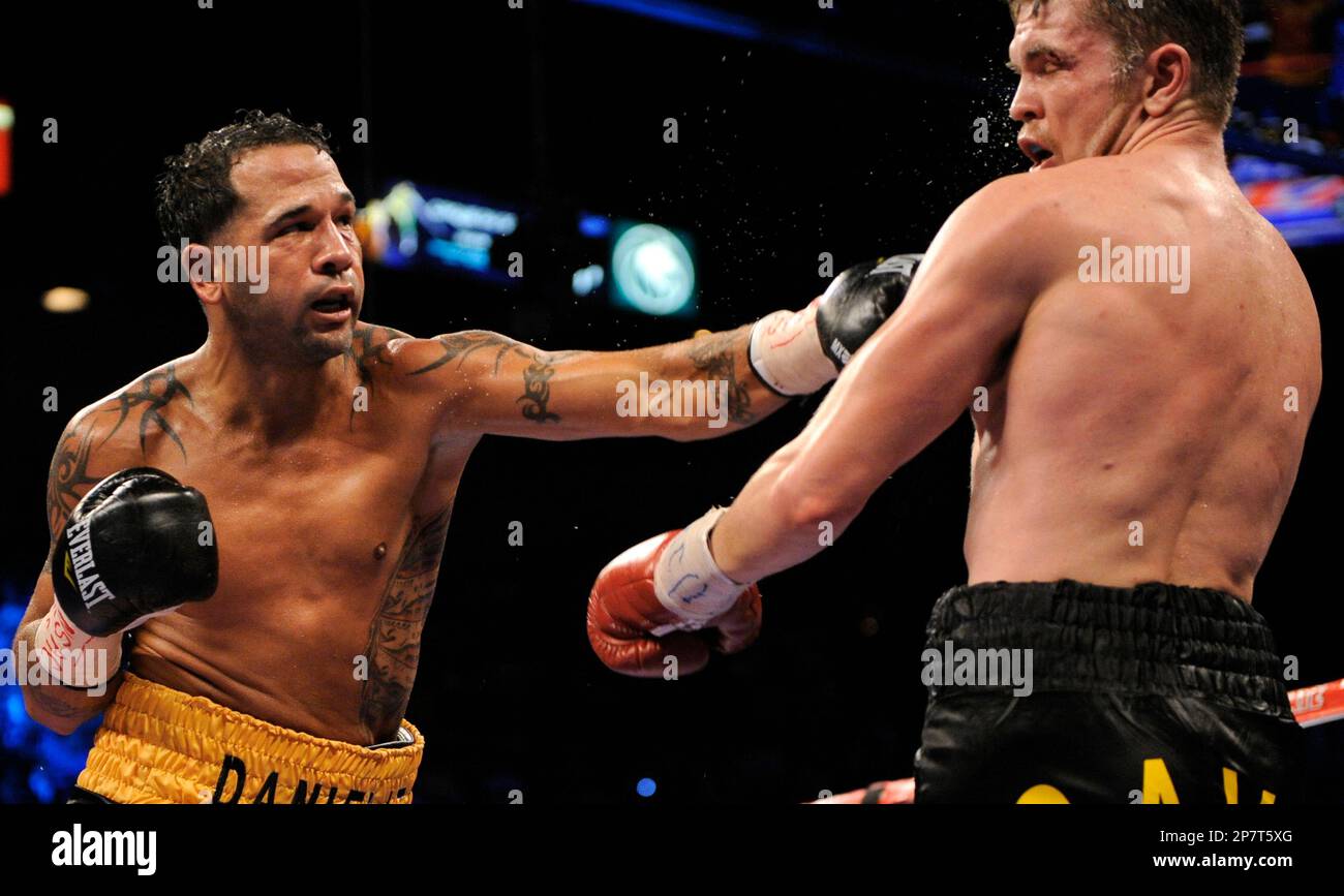 Daniel Santos, from Puerto Rico, left, lands a left to the head of Yuri ...