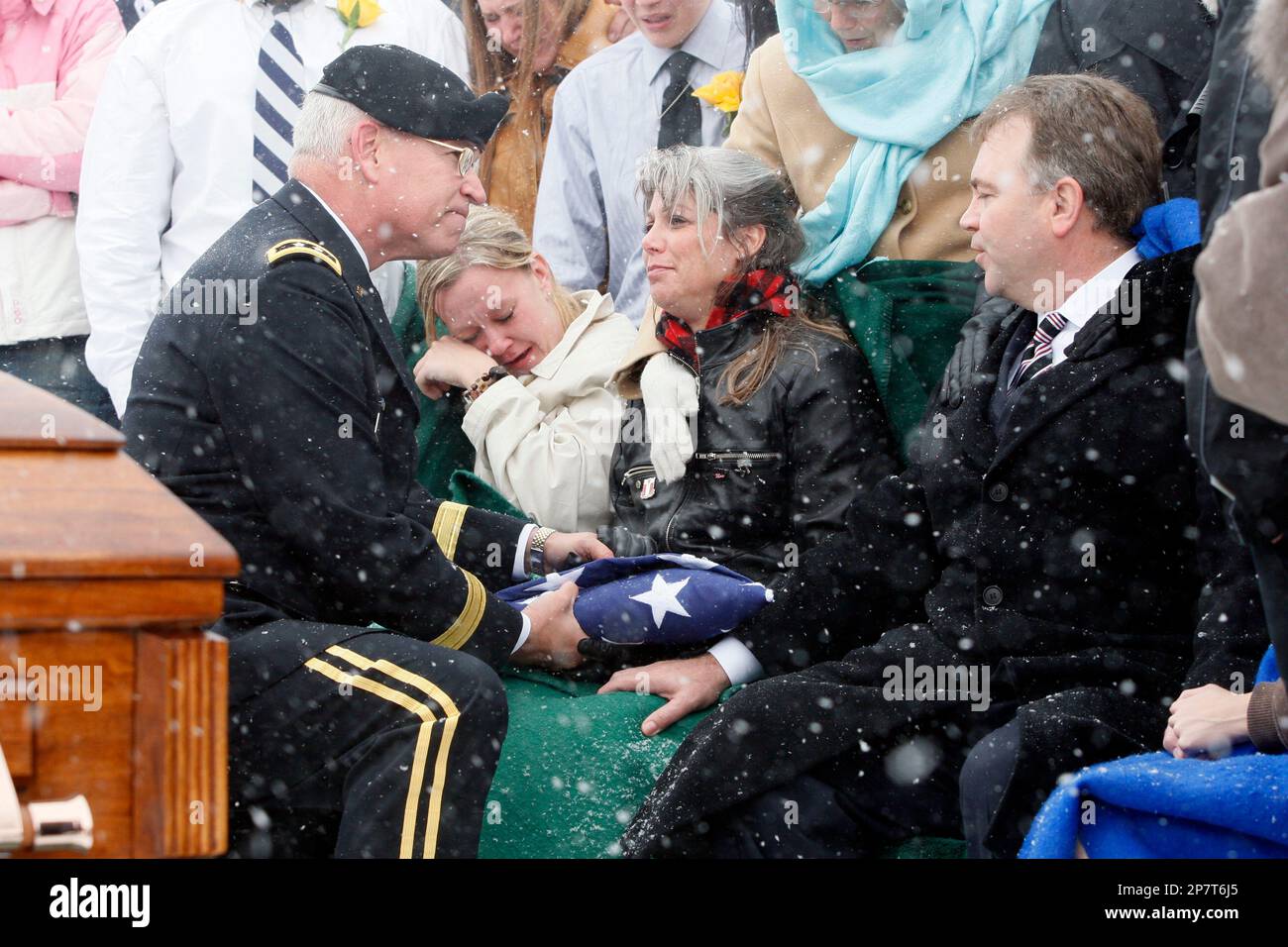 Major General Robert Williams, left, hands the American flag to Teena ...