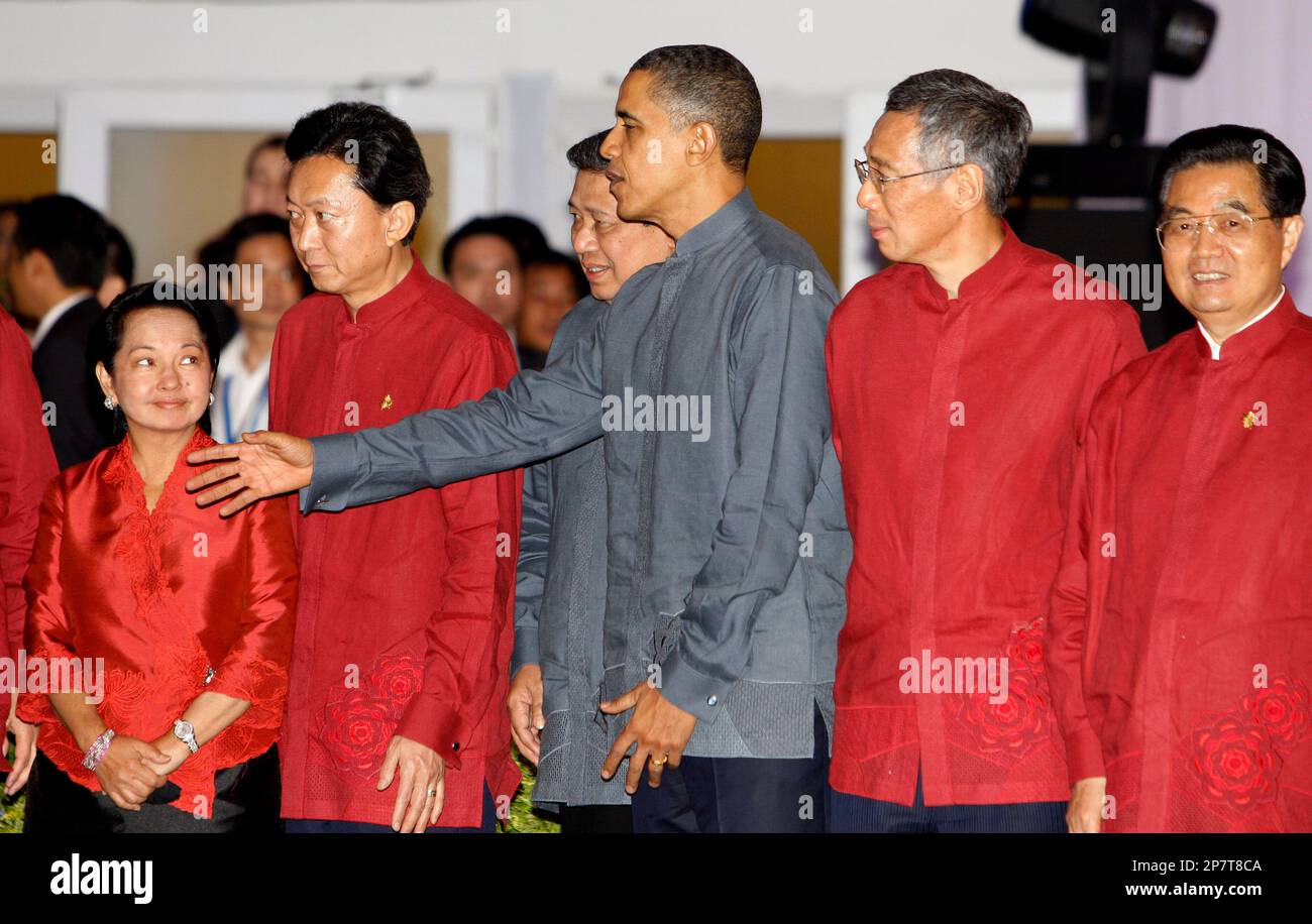 U.S. President Barack Obama gestures as he waits with fellow APEC ...
