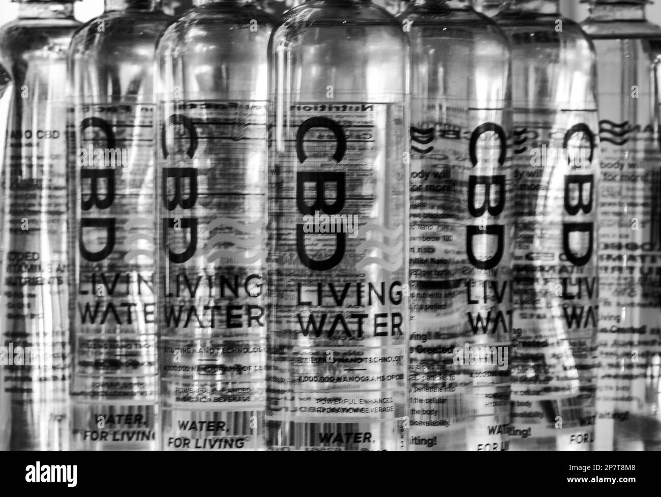 Plastic bottles of CBD Living Water are clustered and displayed for ...