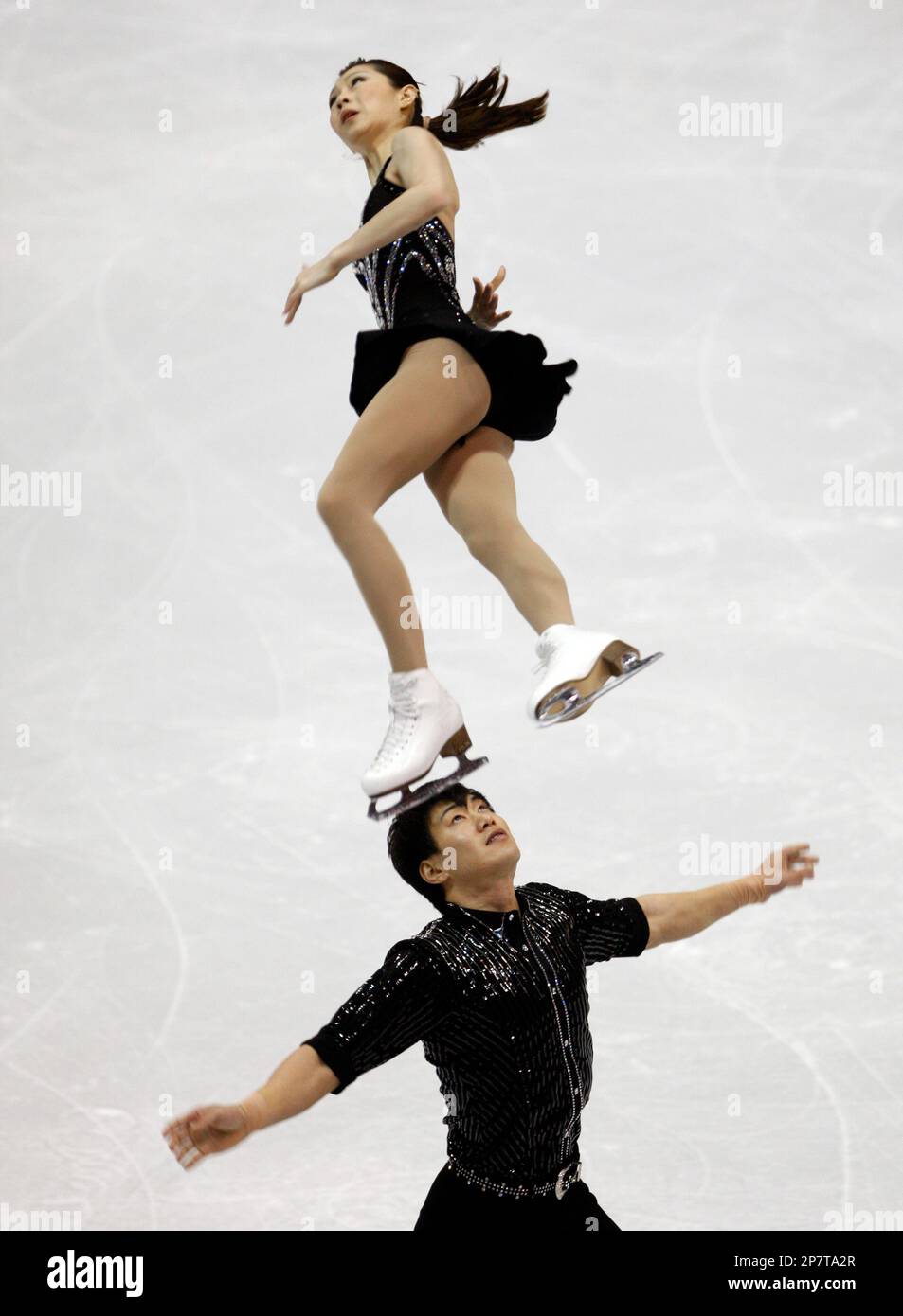 Zhang Dan, top, and Zhang Hao perform during the pairs short program at ...