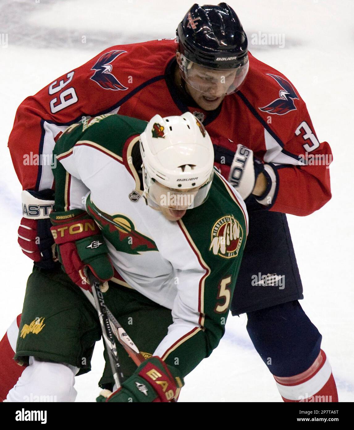 Washington Capitals left winger David Steckel, top, battles Minnesota ...