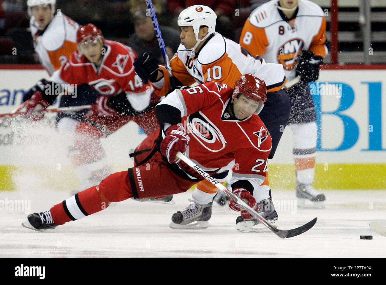 Carolina Hurricanes' Erik Cole (26) falls to the ice as he collides ...
