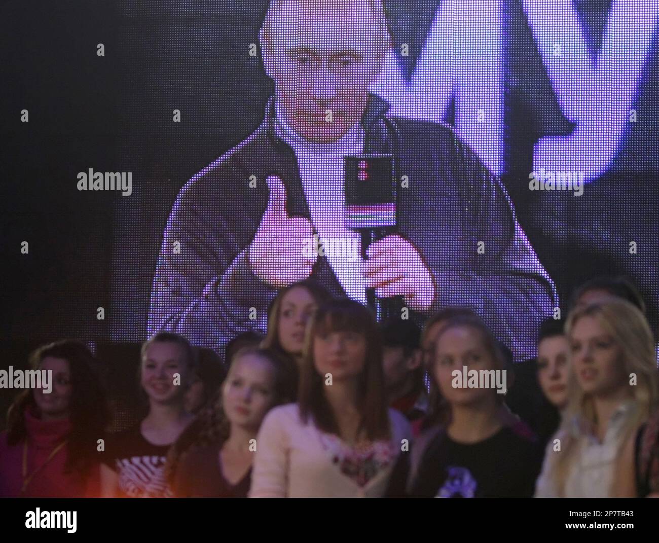 Russian Prime Minister Vladimir Putin holding a microphone is projected ...