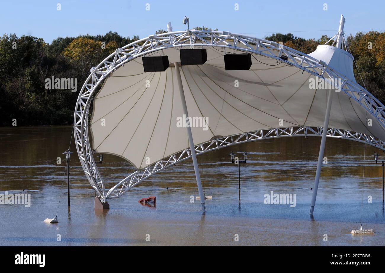 The canopy of an amphitheater stands above flood waters on the ...