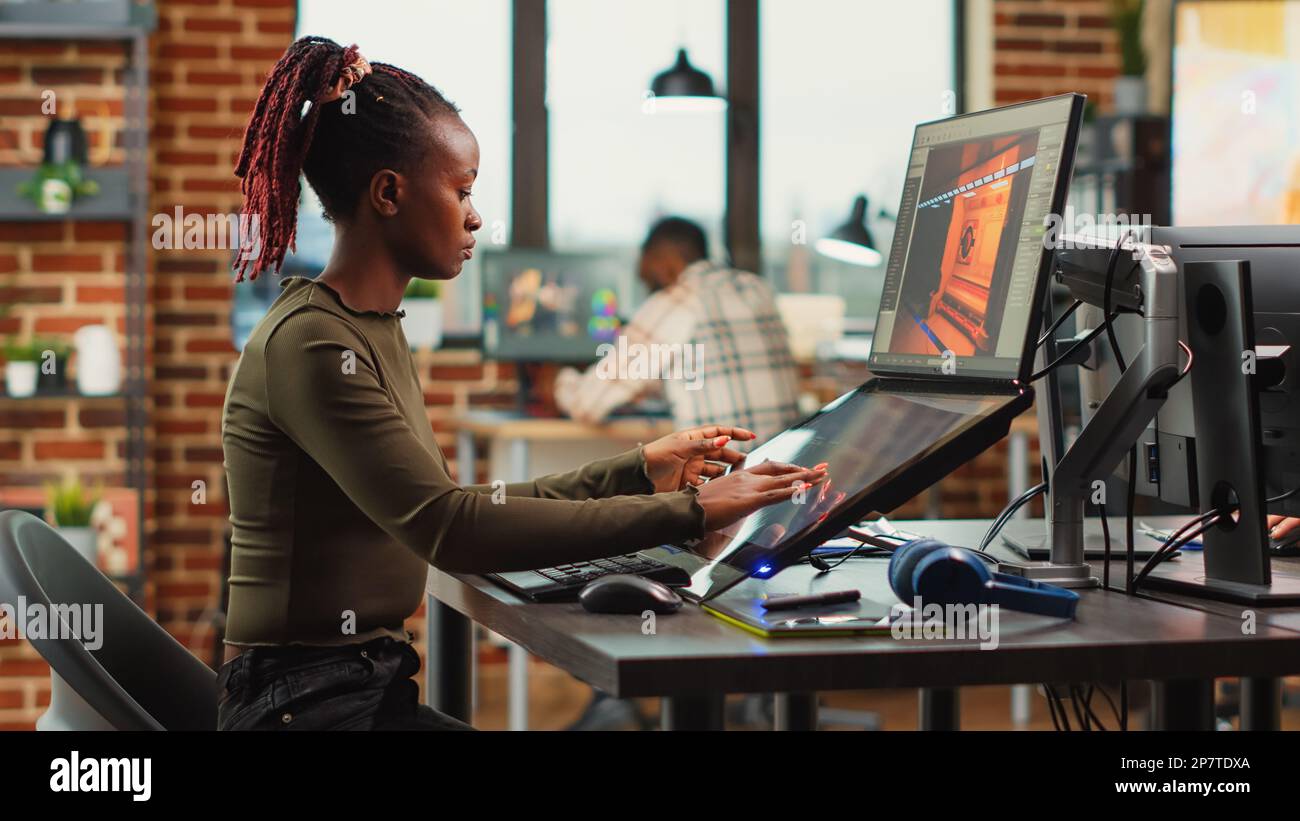 African american woman designing game interface on computer with ...