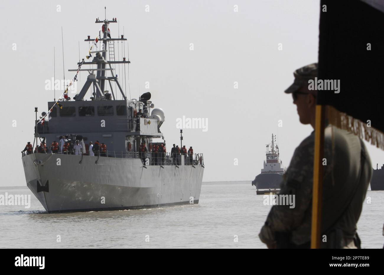 A U.S soldier stands as the Iraqi Navy patrol ship Nasir (Victory) 701 ...