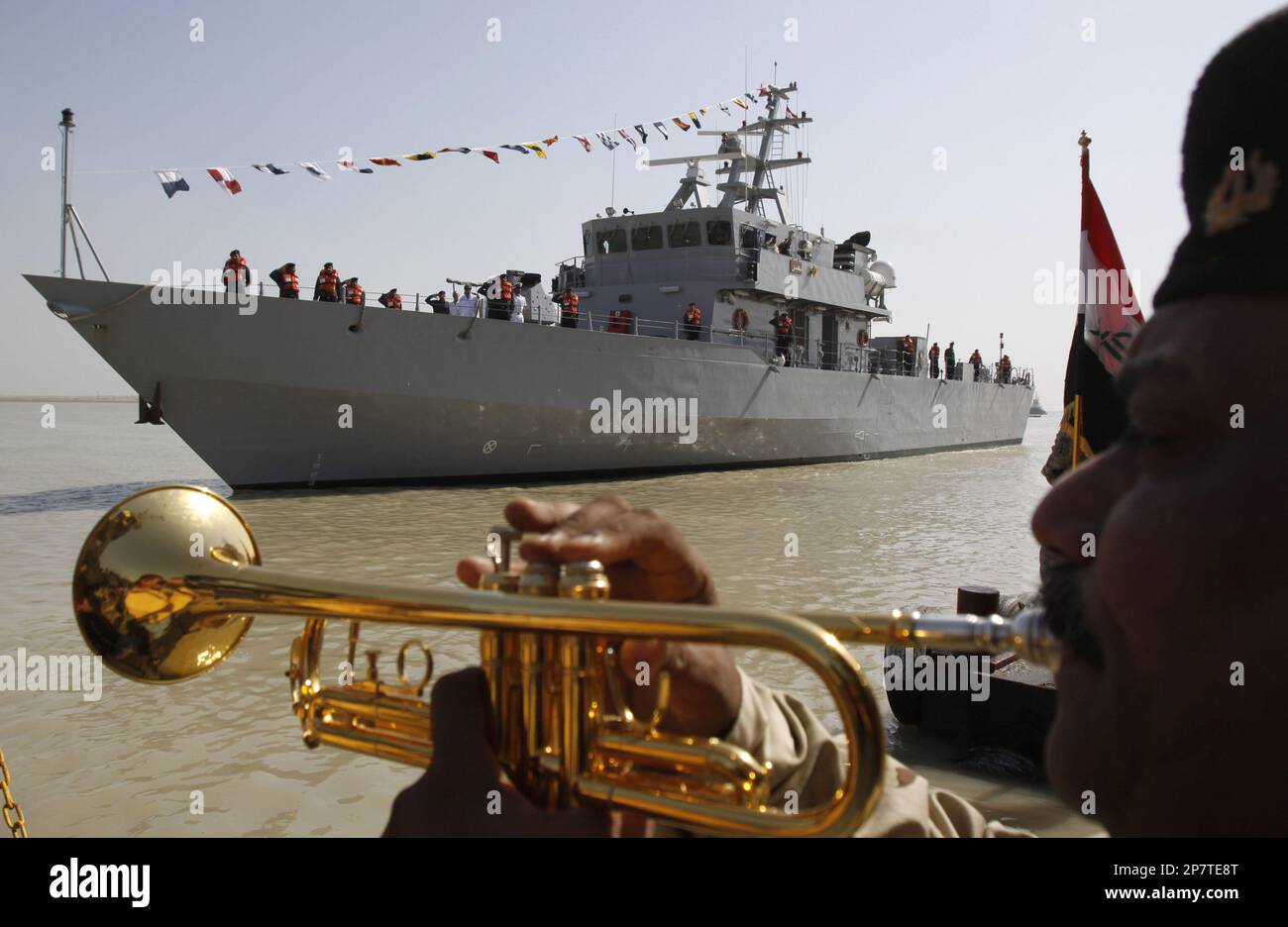 A U.S soldier stands as the Iraqi Navy patrol ship Nasir (Victory) 701 ...