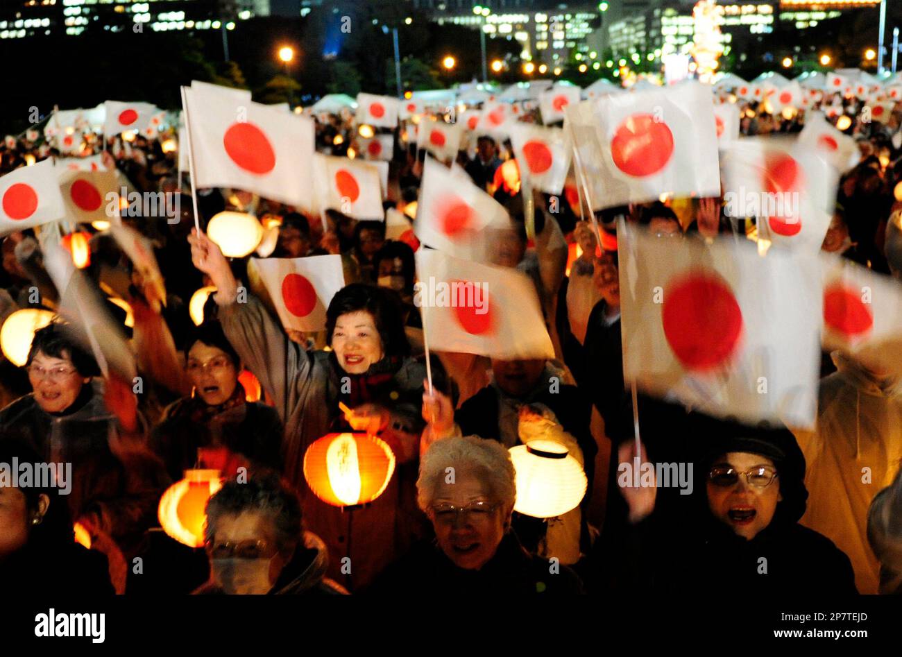 Japanese well-wishers hold paper lanterns as Emperor Akihito and ...