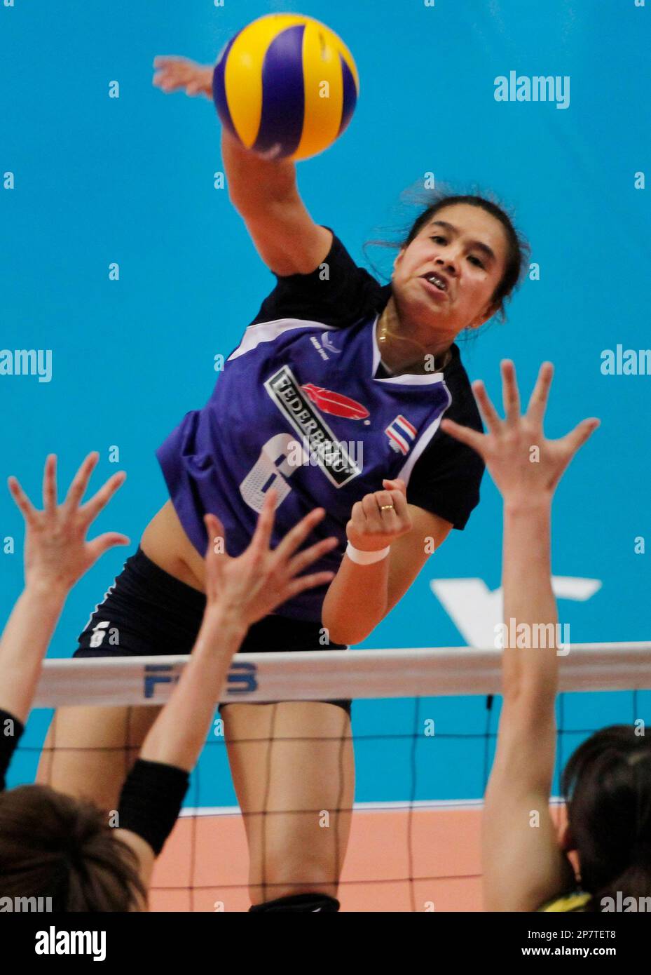 Onuma Sittirak of Thailand spikes the ball against Saori Kimura, left ...