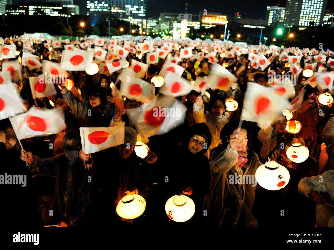 Tens of thousands of ell-wishers wave national flags and lanterns in ...