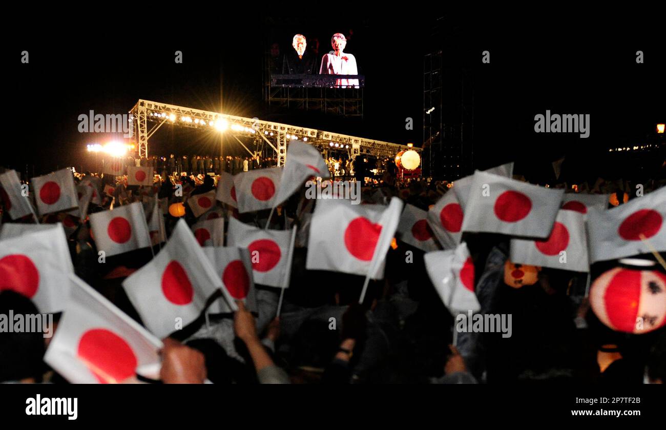 Japanese well-wishers wave national flags and lanterns in front of the ...