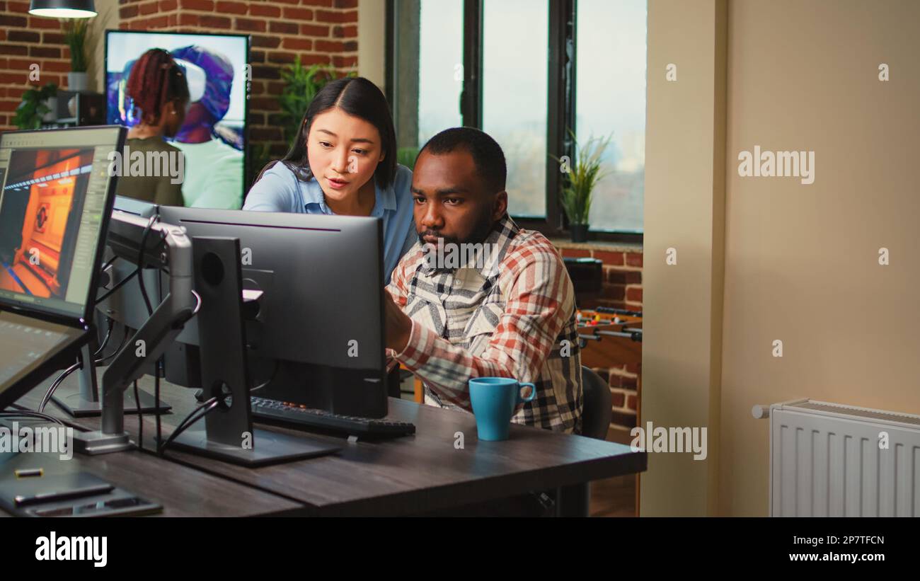 Creative agency employees using computers to develop new graphics ...