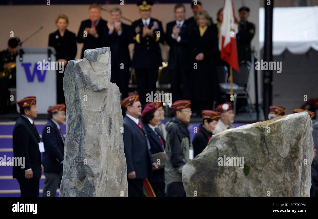 Veterans march past dignitaries and in front of a new memorial ...