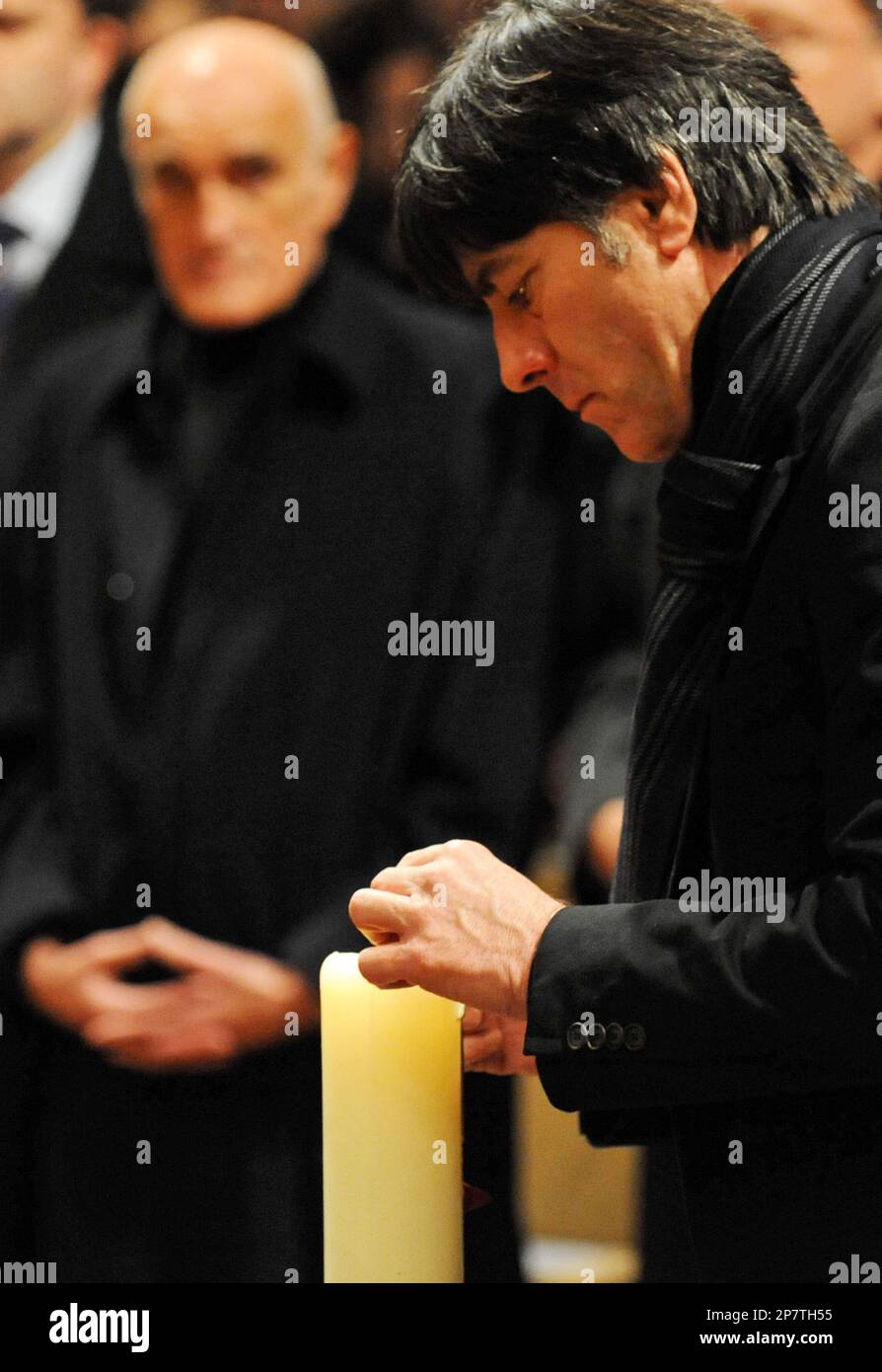German national soccer team coach Joachim Loew lights a candle during a ...