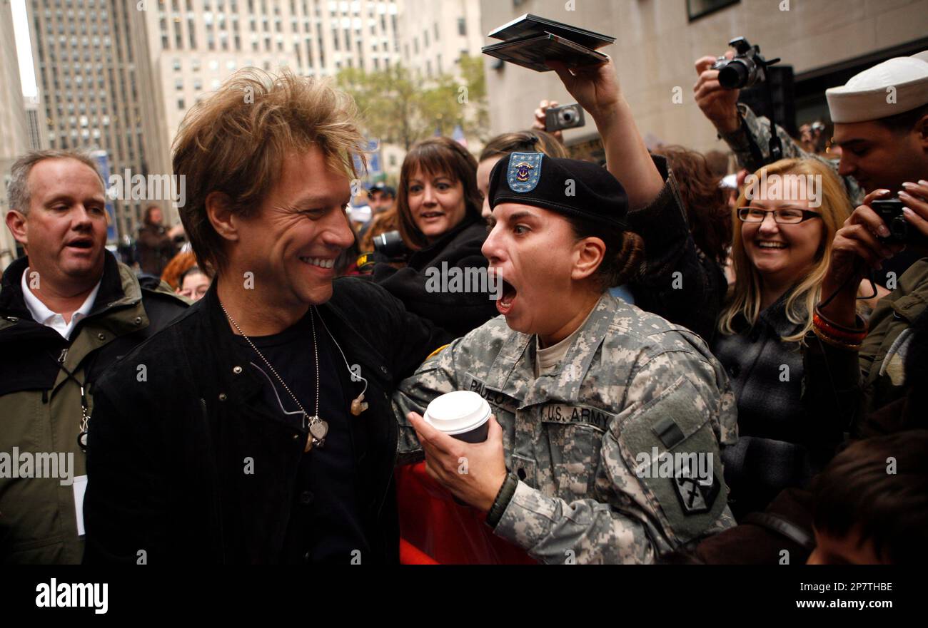 Singer Jon Bon Jovi embraces U.S. Army Spc. Cindy Paulo after ...