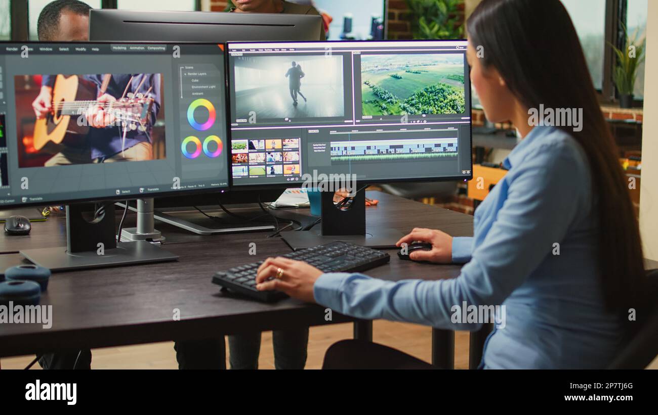 Asian film maker working on movie footage quality with editing software ...