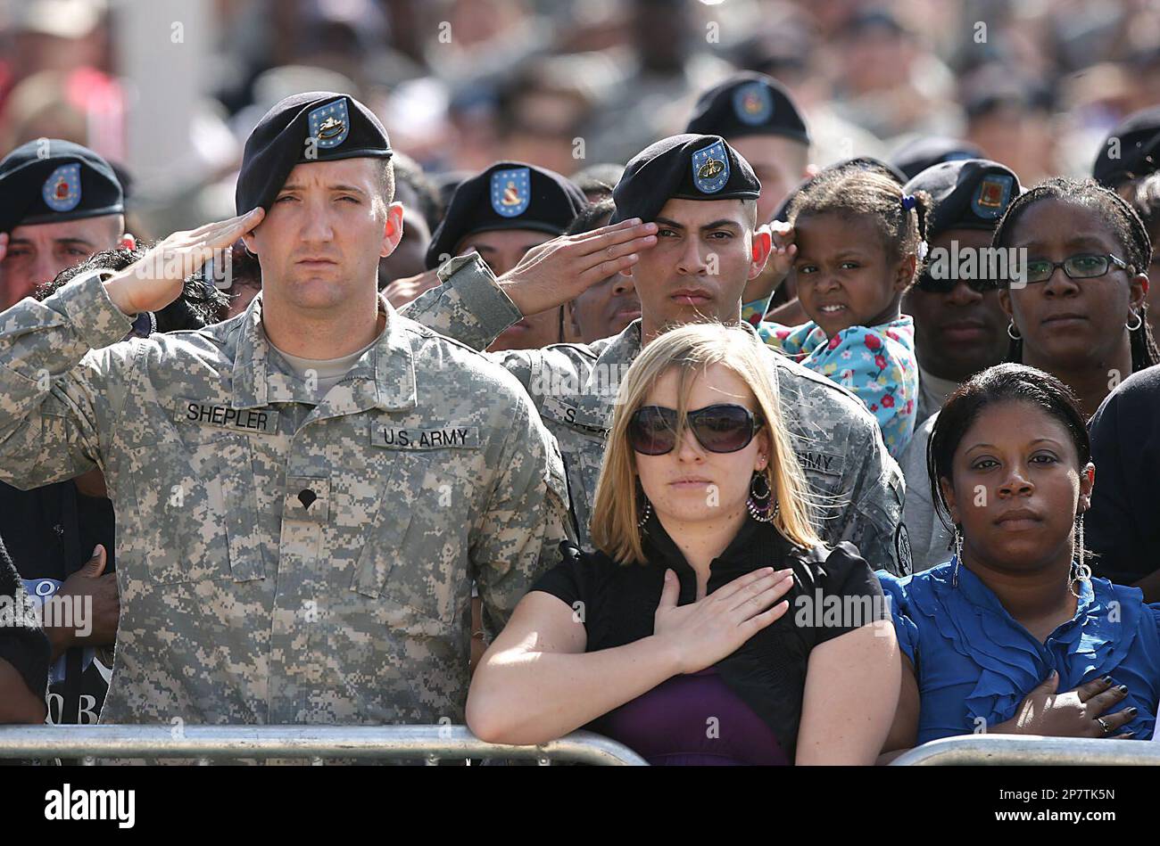 Soldiers And Civilians Stand For The Playing Of The National Anthem