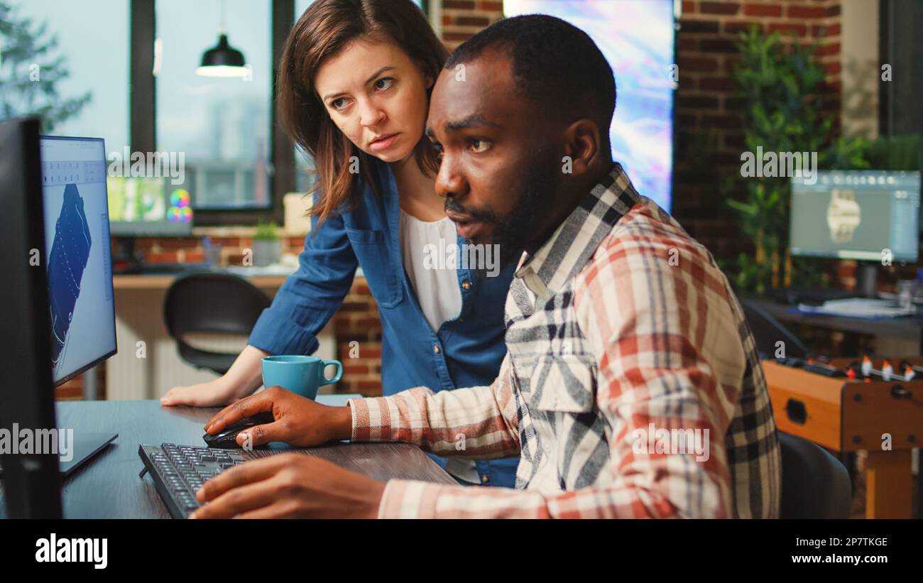 Diverse team of developers working on infographics development, analyzing 3d render software on ...