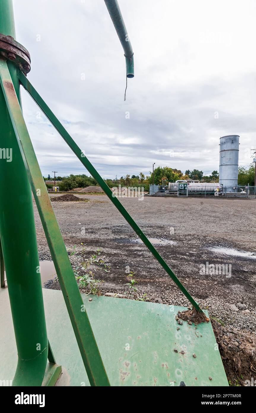 An elevated green pipe and pedestal support for liquid or gas delivery ...