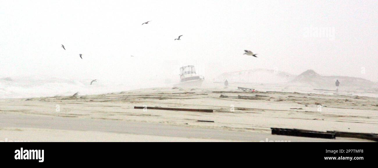 A beached boat and other debris sit on the beach as winds from Tropical ...