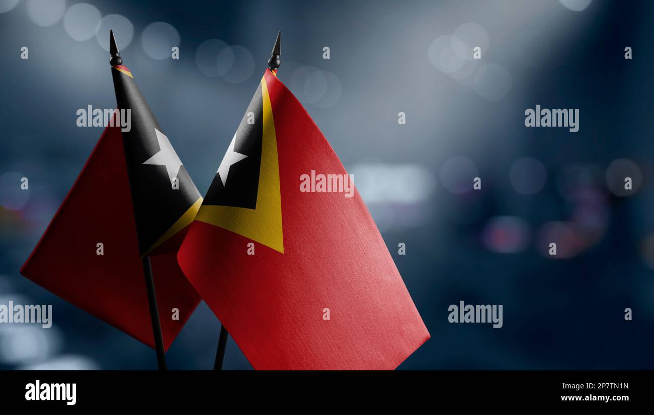 Small flags of the East Timor on an abstract blurry background Stock ...