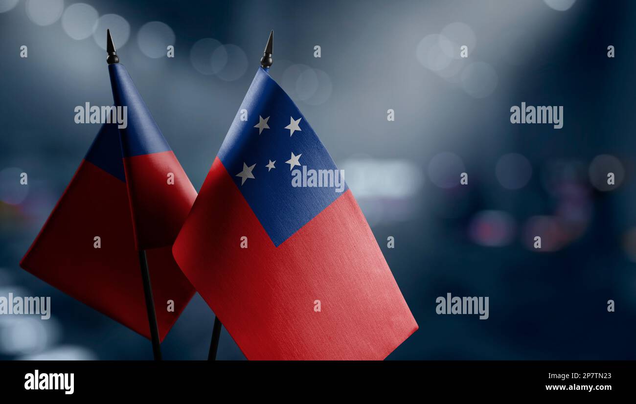 Small flags of the Samoa on an abstract blurry background Stock Photo ...