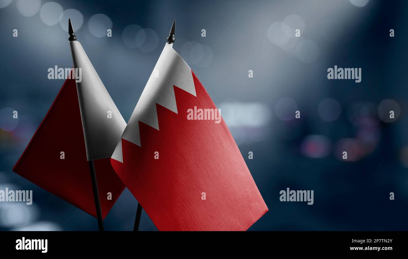 Small flags of the Bahrain on an abstract blurry background Stock Photo ...