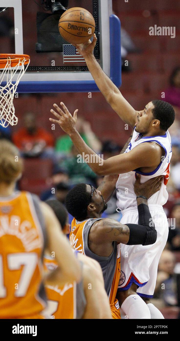 Philadelphia 76ers' Rodney Carney, right, is fouled by Phoenix Suns ...
