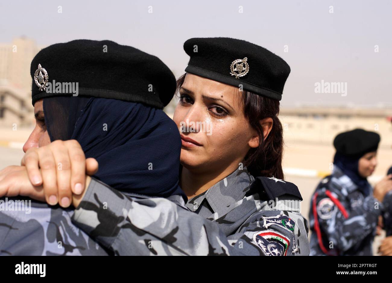 A newly graduated Iraqi police women sheds tears during a graduation ...