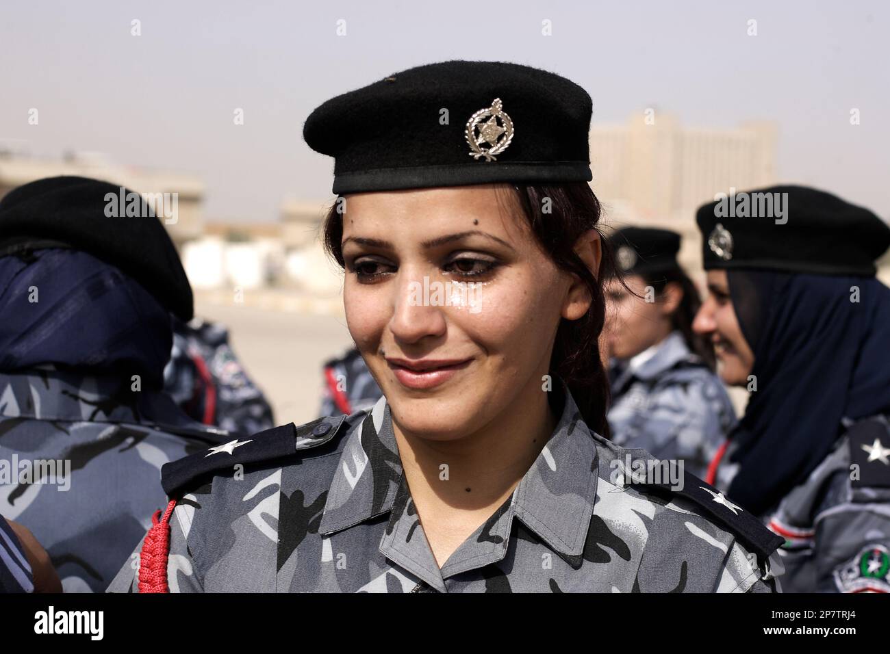 A newly graduated Iraqi police women sheds tears during a graduation ...
