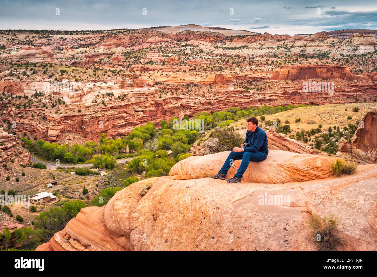 Hiker rests above the Escalante River canyon in Grand Staircase ...