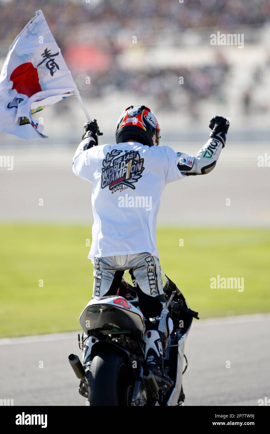 250cc Honda rider Hiroshi Aoyama of Japan celebrates on a lap of honour ...