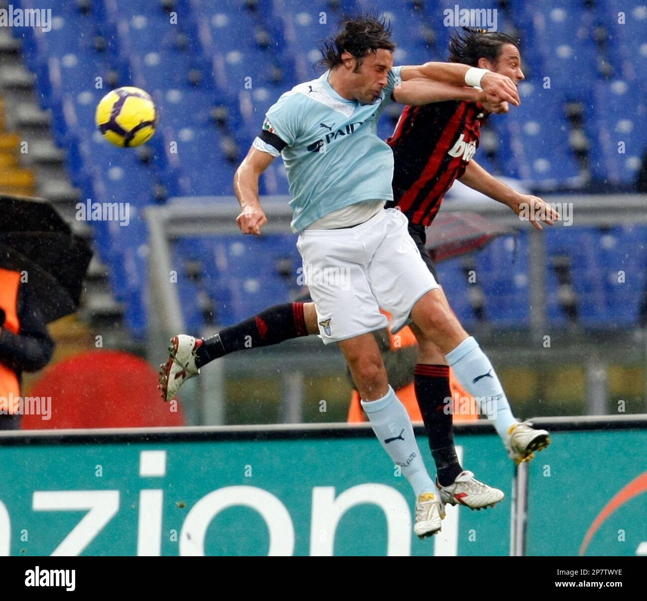 Lazio's Stefano Mauri, left, and AC Milan's Massimo Oddo jump for the ...