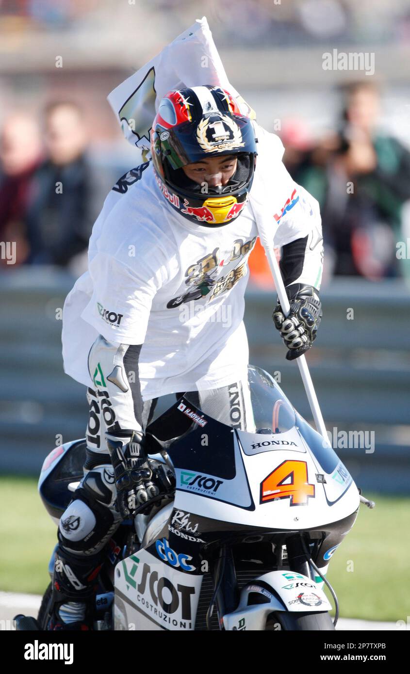 250cc Honda rider Hiroshi Aoyama of Japan celebrates on a lap of honour ...