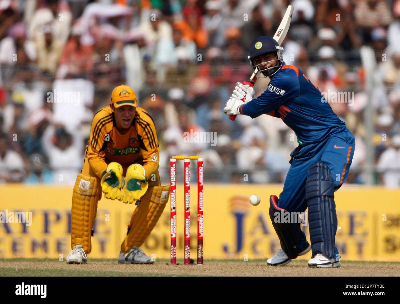 India's Praveen Kumar, right, sights a ball as Australia's wicketkeeper ...
