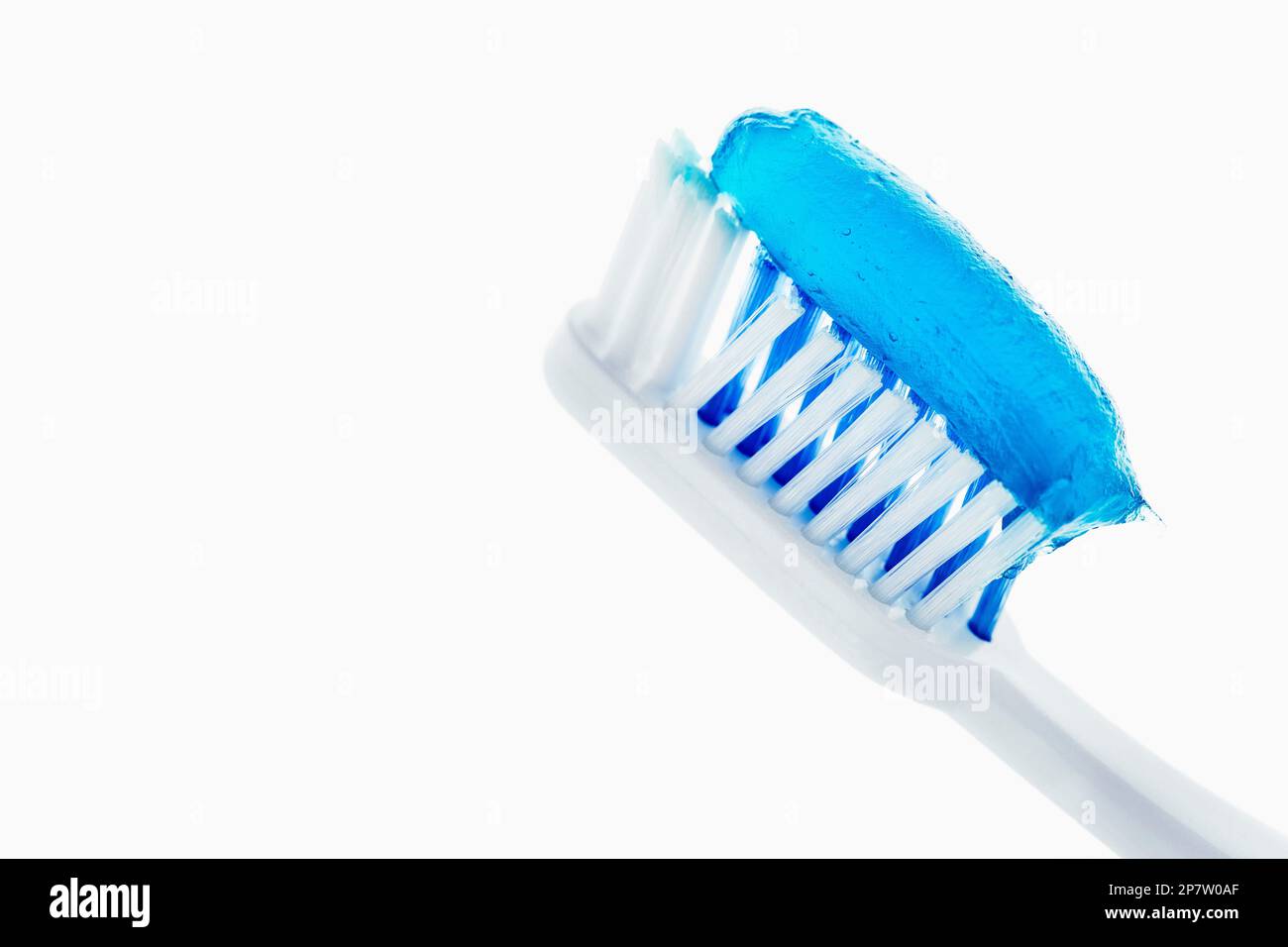 Blue toothpaste on a toothbrush for daily dental cleaning. Still life ...
