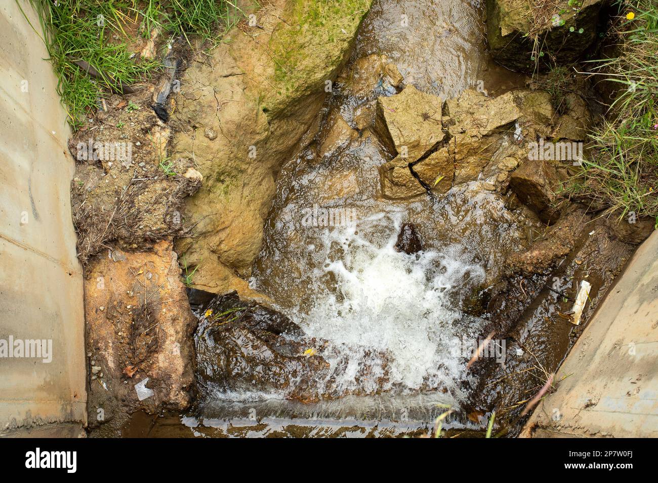 Drain with contaminated water discharging into a stream Stock Photo - Alamy