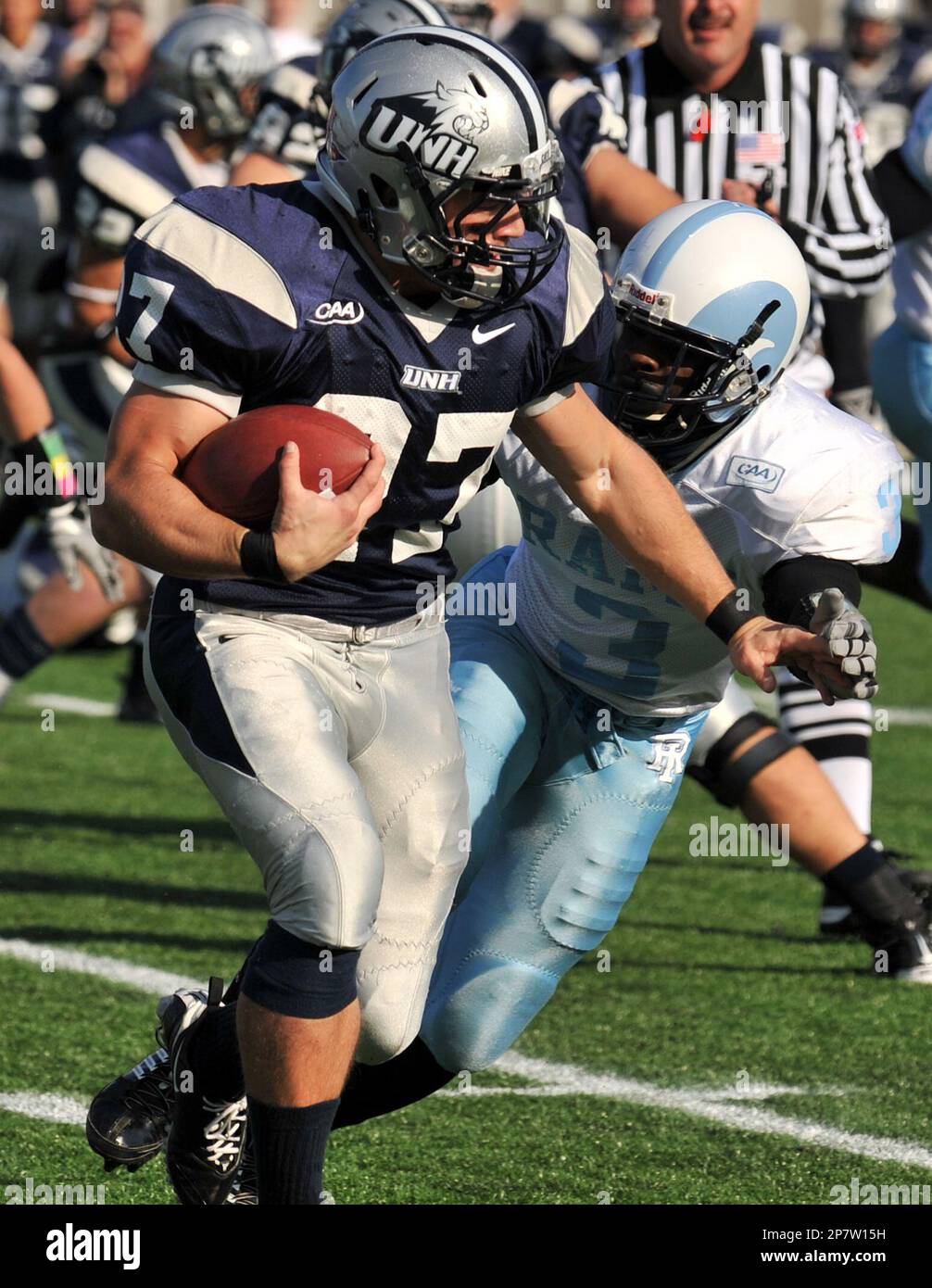 New Hampshire running back Chad Kackert, left, runs past Rhode Island ...