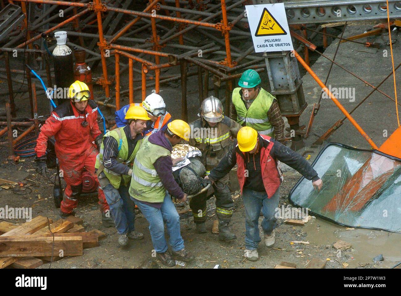 Rescuers carry an injured worker from a bridge under construction that ...