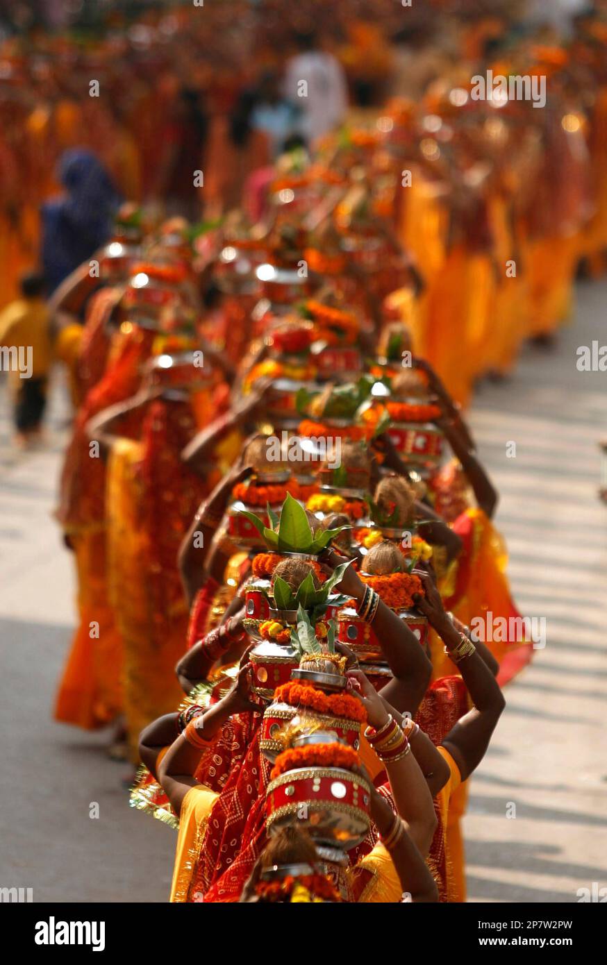 Hindu devotees carry the water from River Ganges, holy to Hindus, in ...
