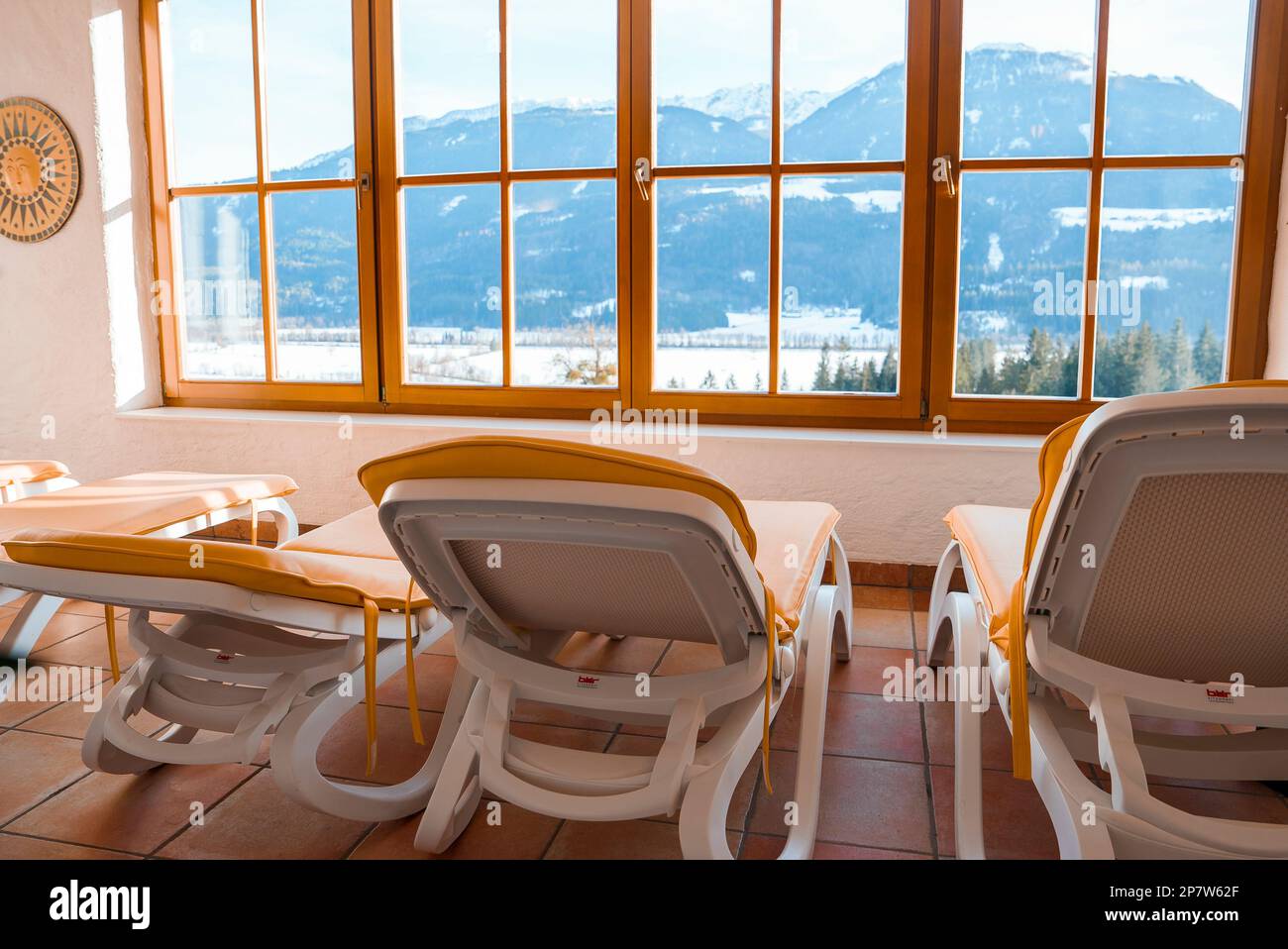 Empty lounge chairs in front of windows at luxury hotel Stock Photo - Alamy