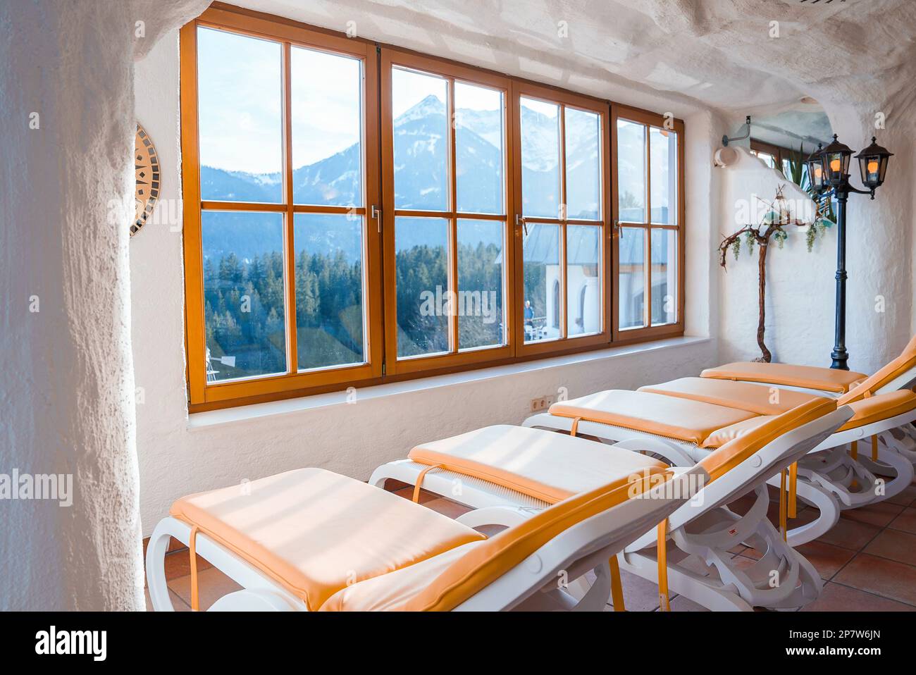 Empty white lounge chairs in front of windows at luxury hotel Stock ...