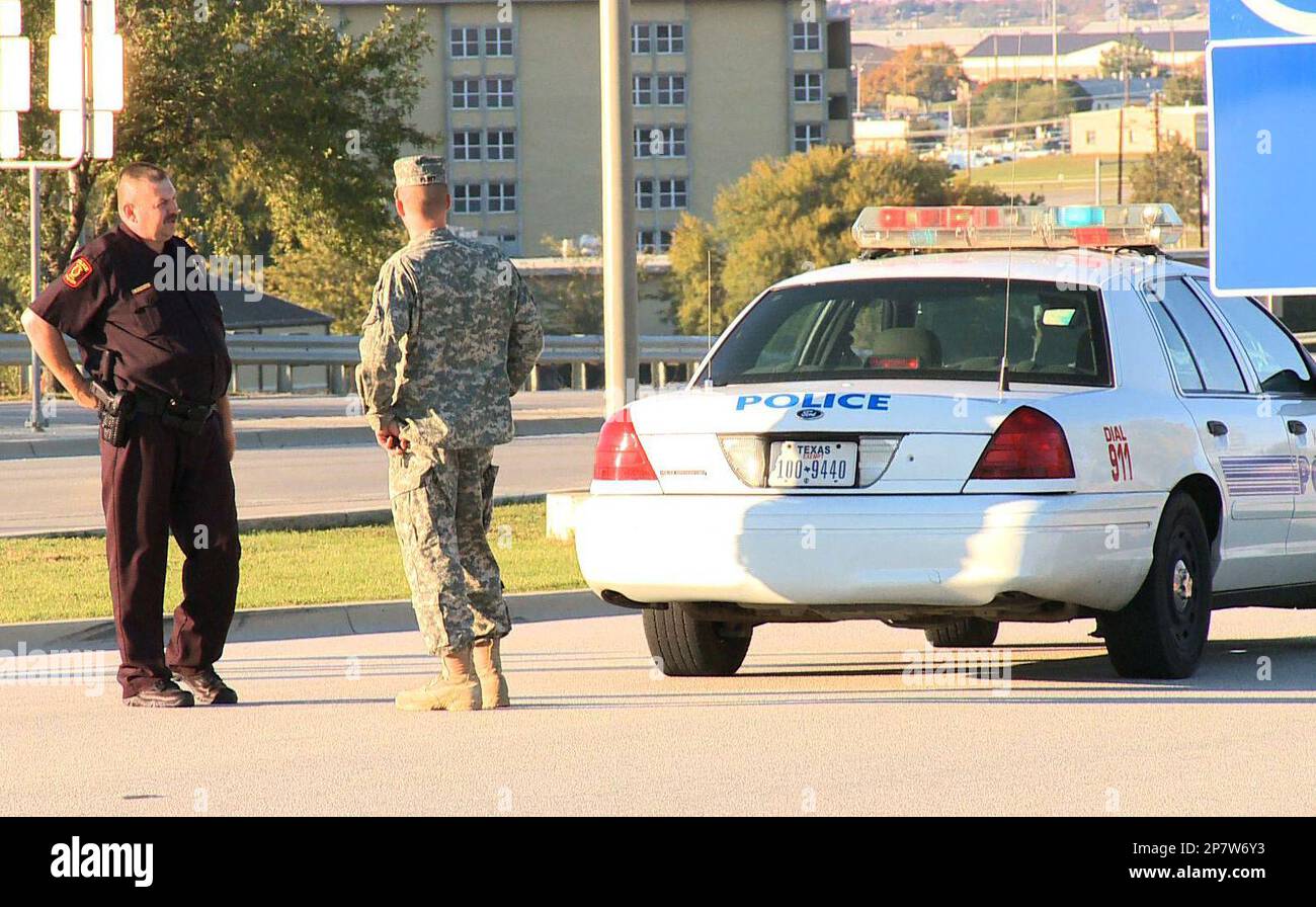 This still made from video shows a police officer and soldier blocking ...