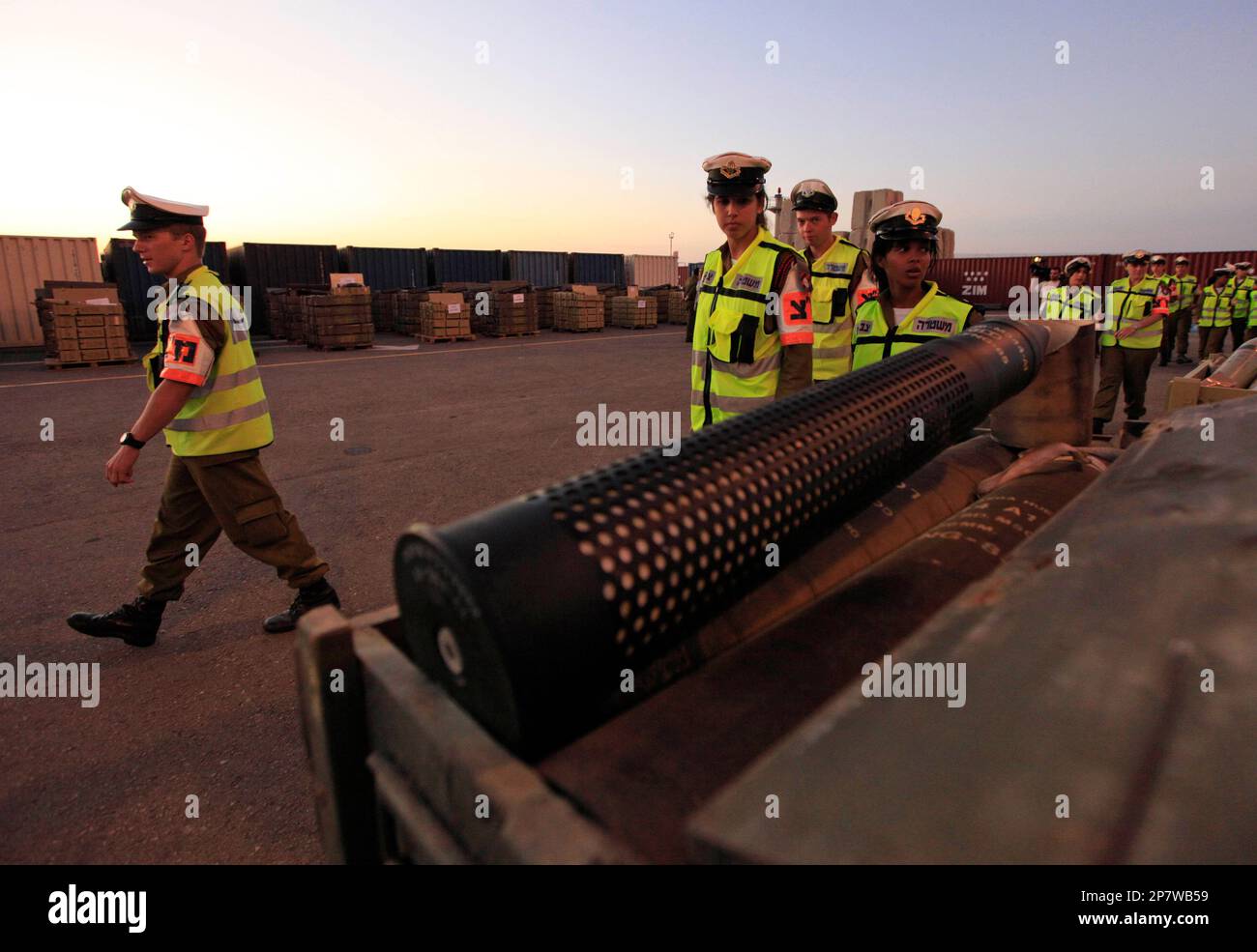 Israeli military police officers stand next to rockets seized by ...
