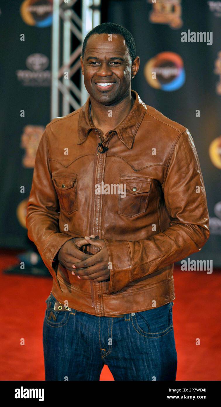 Brian McKnight smiles as he poses on the red carpet as he enters the ...
