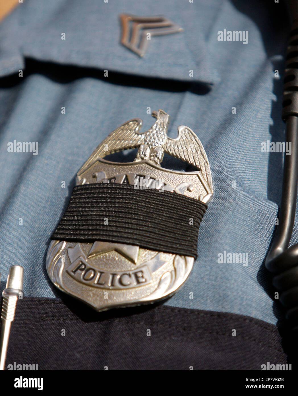 The badge of Seattle police acting Sgt. Adonis Topacio is partially ...